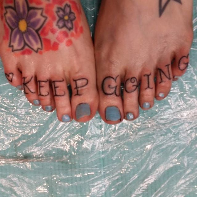 Keep Moving Forward Foot Tattoo