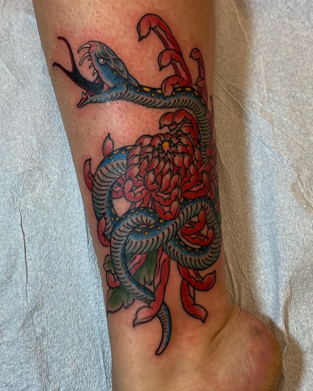 Japanese Snake & Chrysanthemum Forearm Tattoo • Tattoodo
