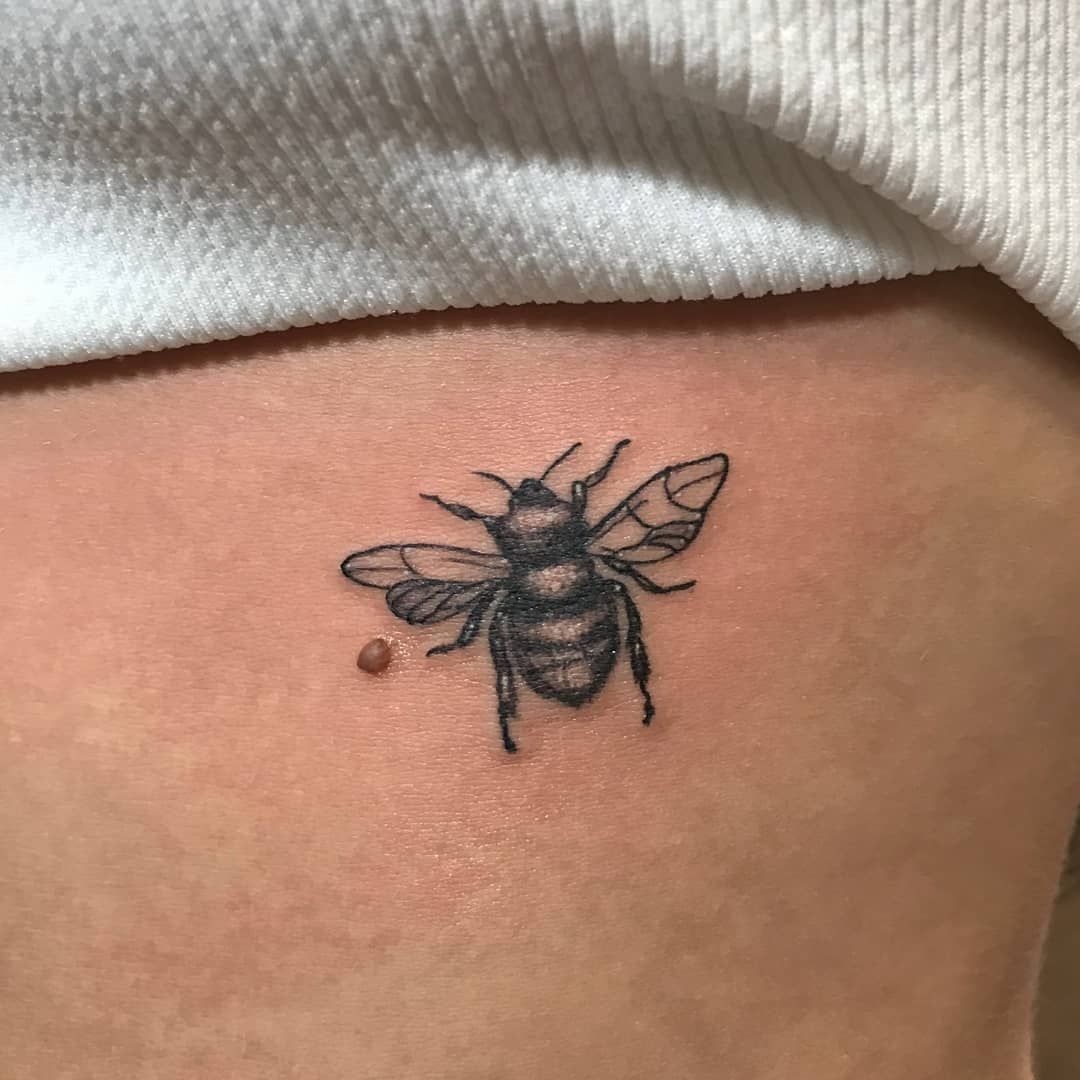 Fine Line Bee Tattoo on Ribs • Tattoodo