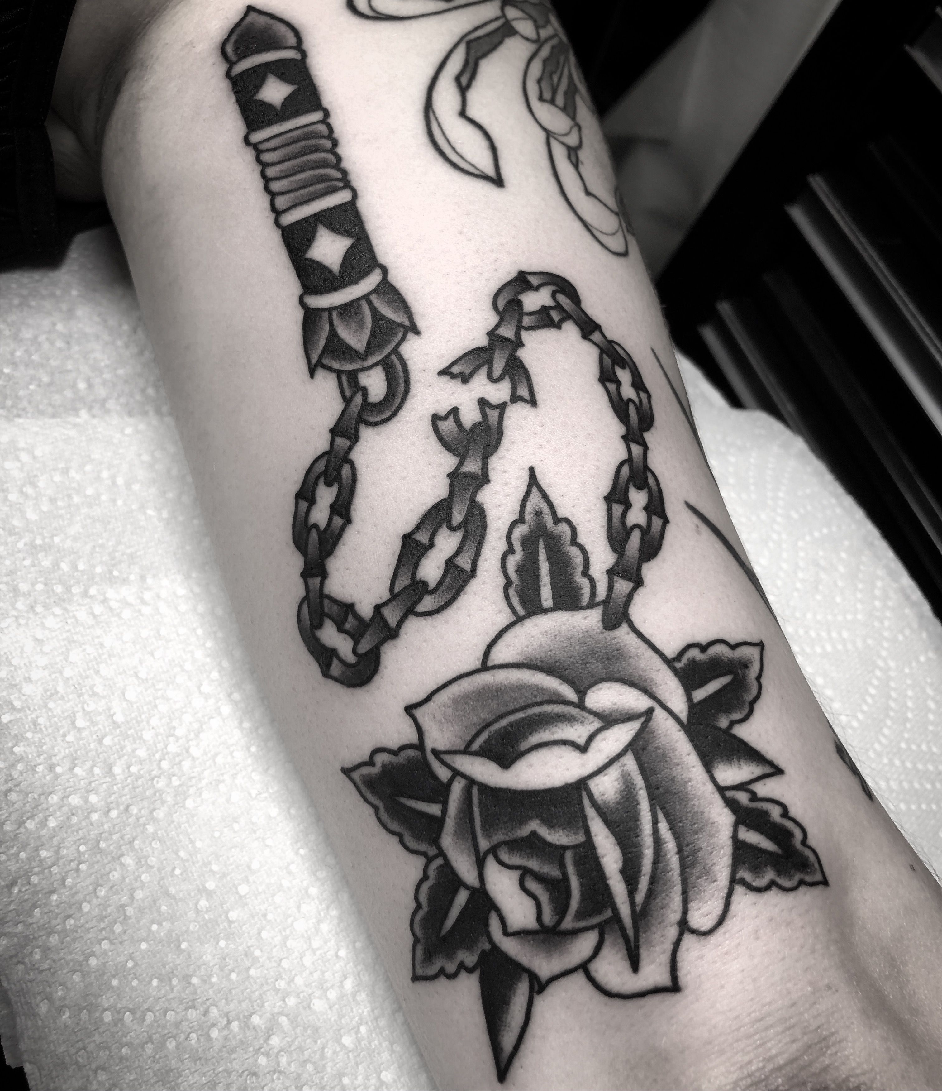 Traditional Flower and Chain Upper Arm Tattoo • Tattoodo