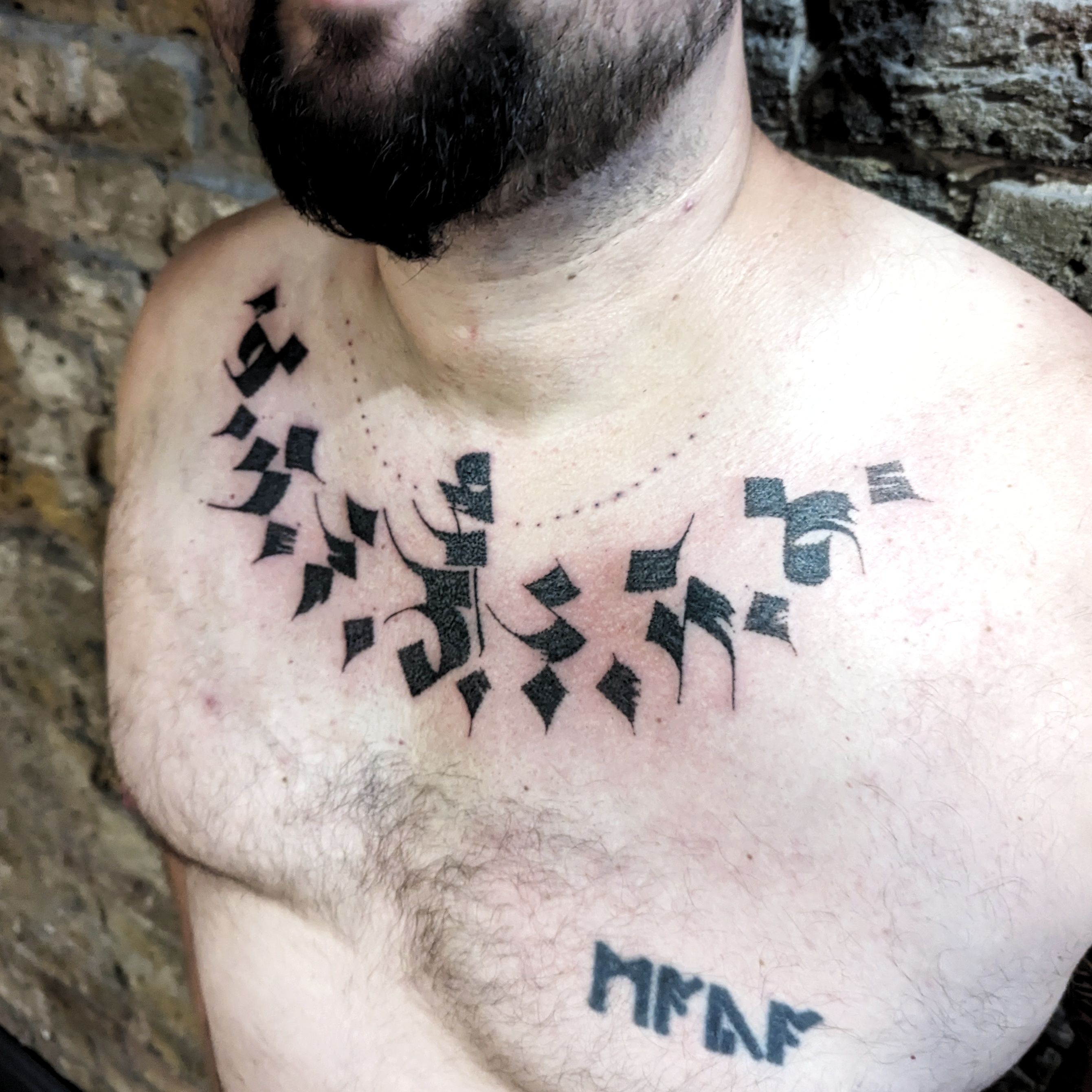 Chun Lee's Blackwork Tribal Quote on Chest • Tattoodo