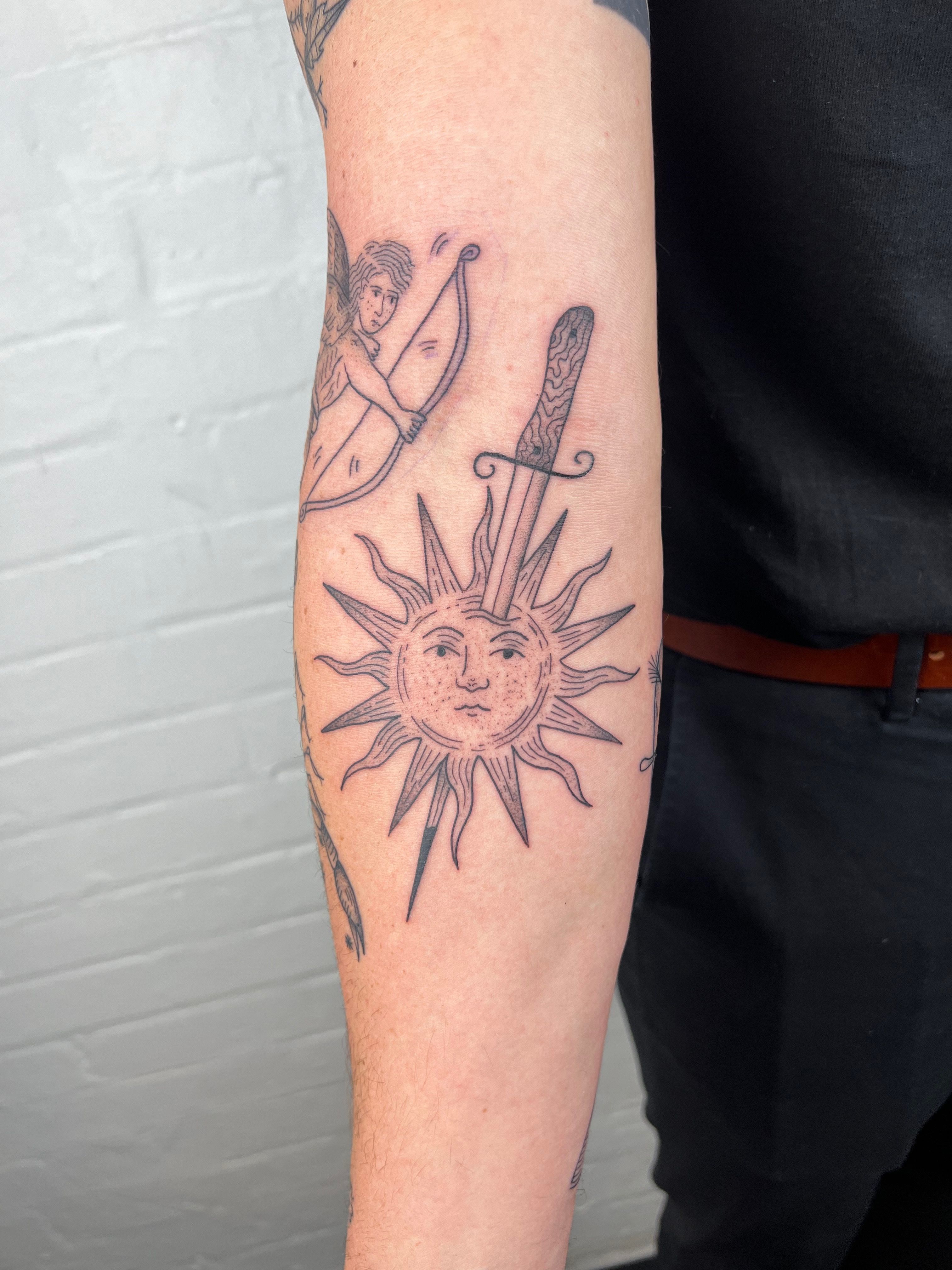 Sun, Sword, and Eyes Forearm Tattoo • Tattoodo