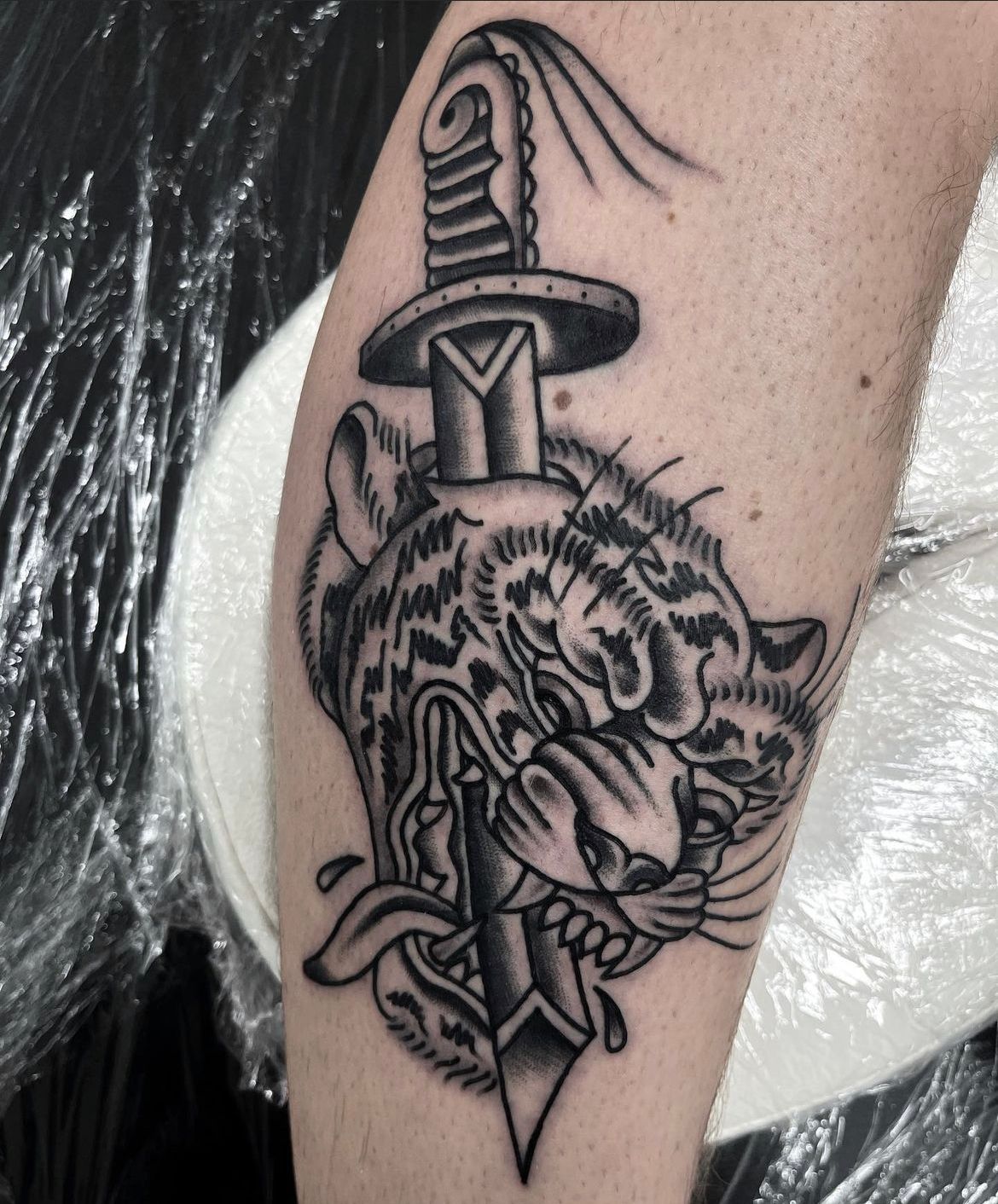 Traditional Tiger and Sword Lower Leg Tattoo • Tattoodo