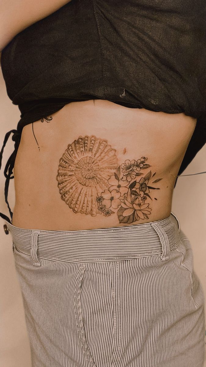 Tattoo uploaded by Milky Blue • Fine-line ammonite with flowers on the ...