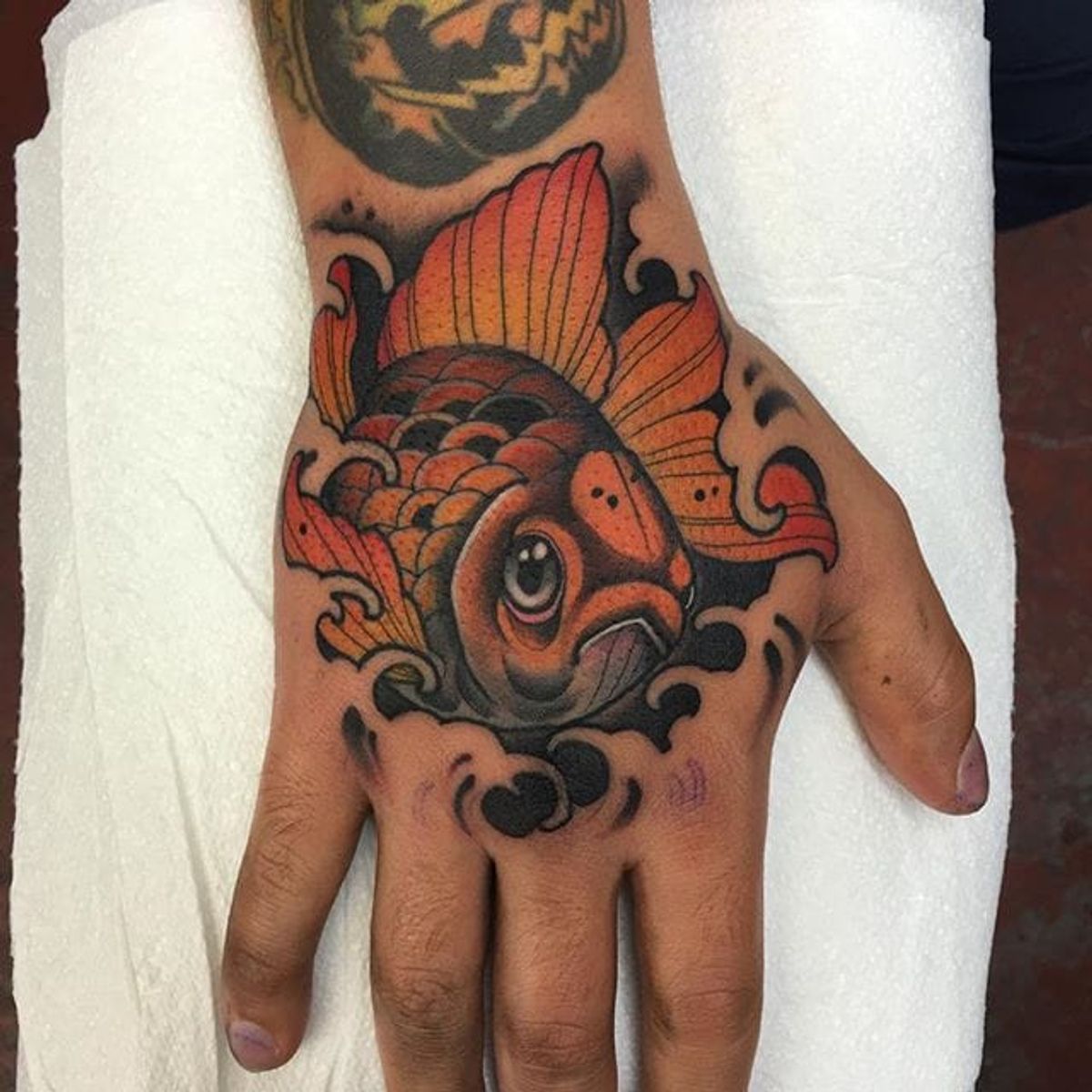 Tattoo uploaded by Robert Davies • Goldfish Hand Tattoo by Mitchell ...